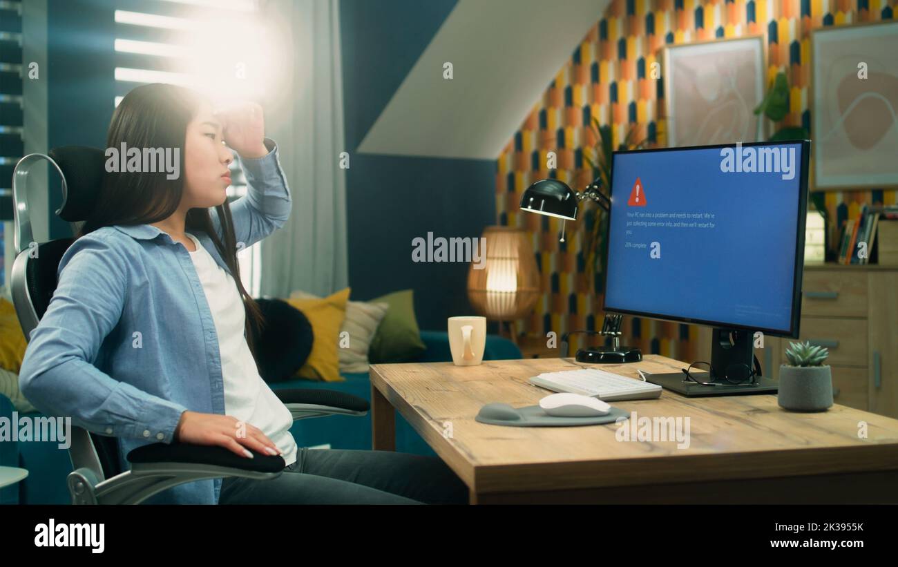 Asian female 3D designer getting angry over computer error while ... Asian female 3D designer getting angry over computer error while ...