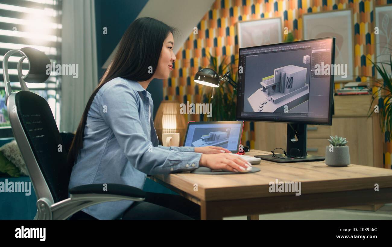Female asian 3D designer at home working on 3D modeling project of ...