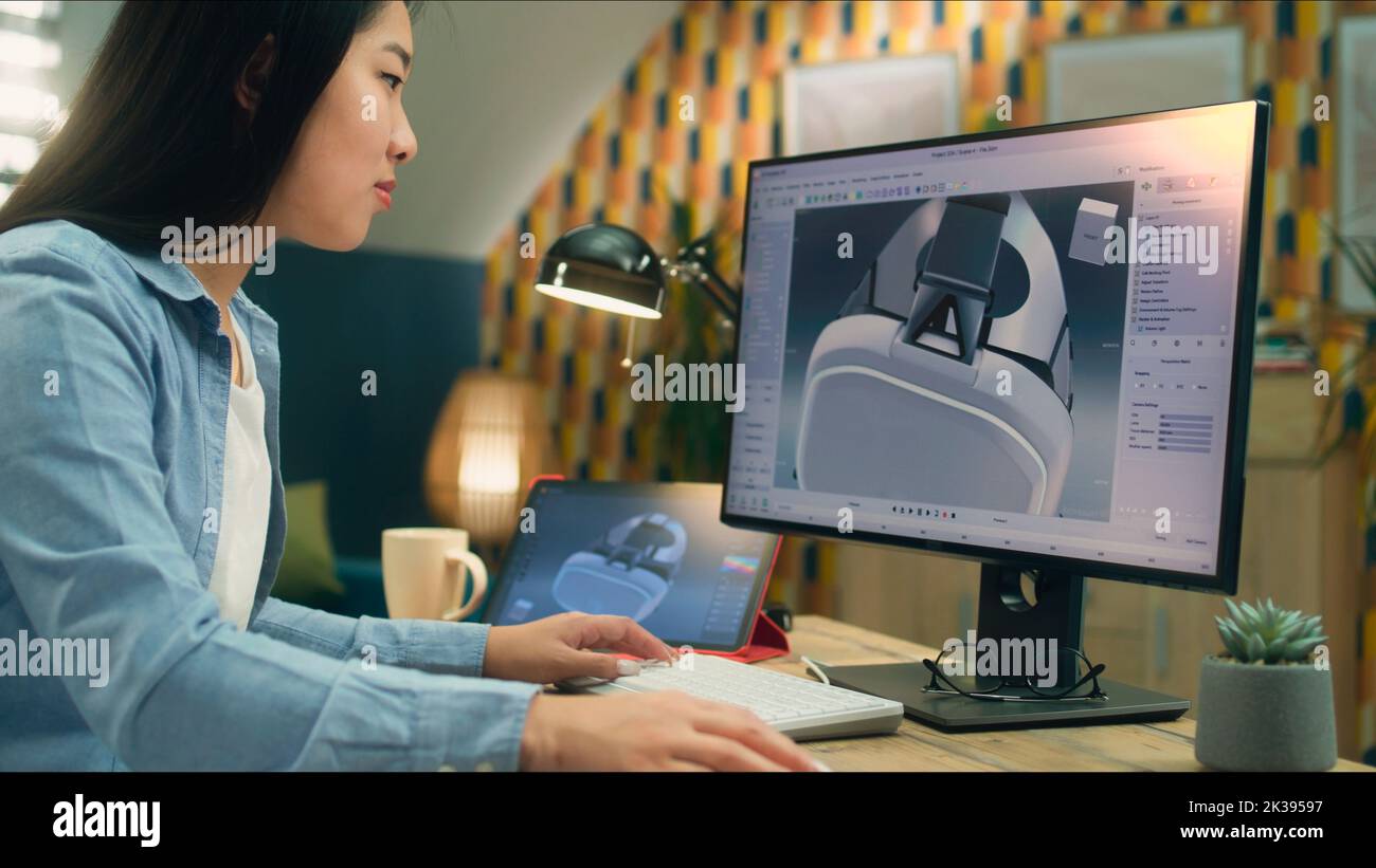 Asian female freelancer working from home office and creating 3D prototype of modern VR headset ...