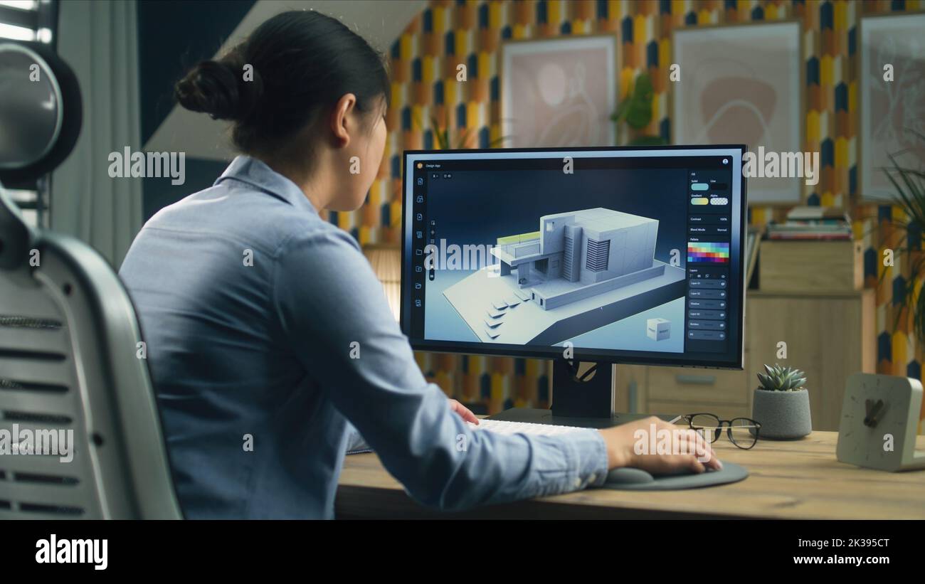 Female 3D designer at home working on 3D modeling project of house and ...