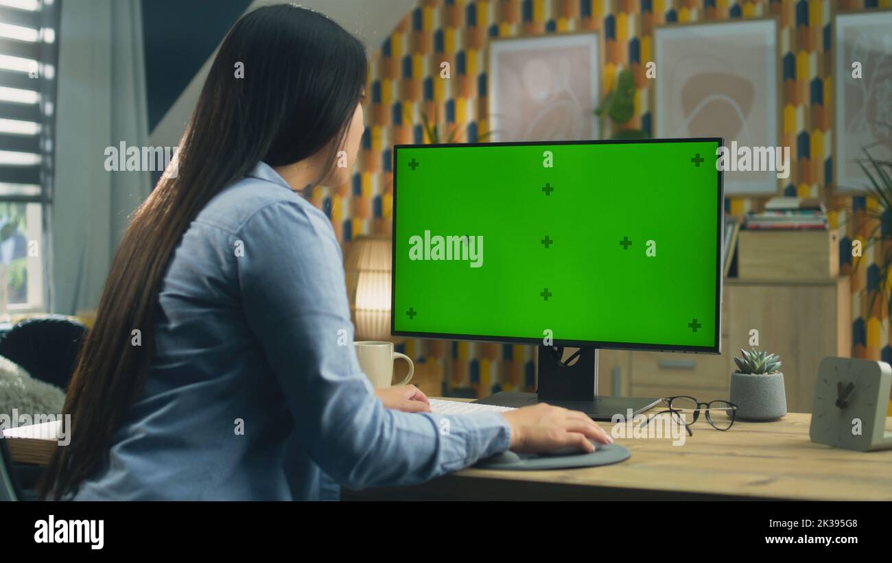 Woman looking computer green screen hi-res stock photography and images ...