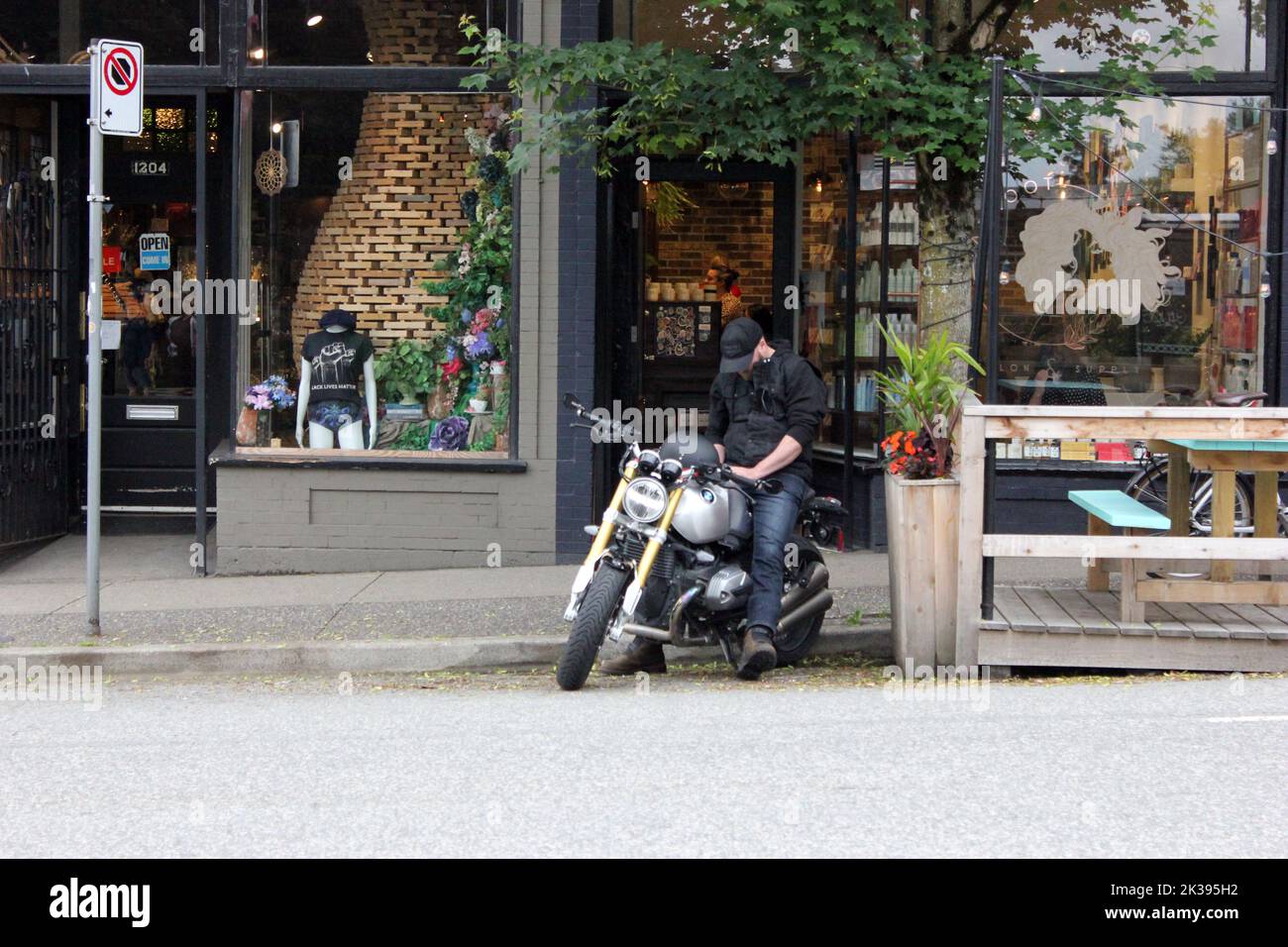 A young man on his motorcycle on Commercial Drive in Vancouver, British ...