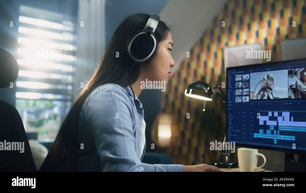 Asian woman in headset editing video with astronauts for client in program on personal computer ...