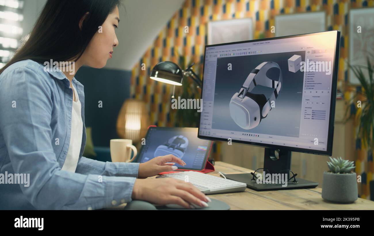 Asian female freelancer working from home office and creating 3D prototype of modern VR headset ...
