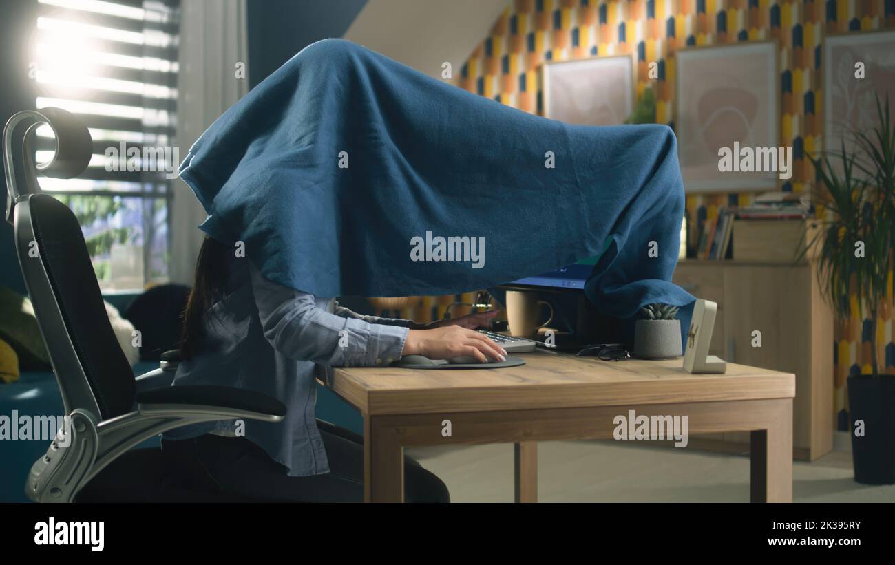 Woman sitting on chair at the table at home and doing color correction ...