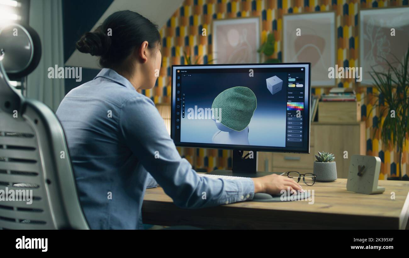 Female designer creating 3D visualization of clothes using computer and ...