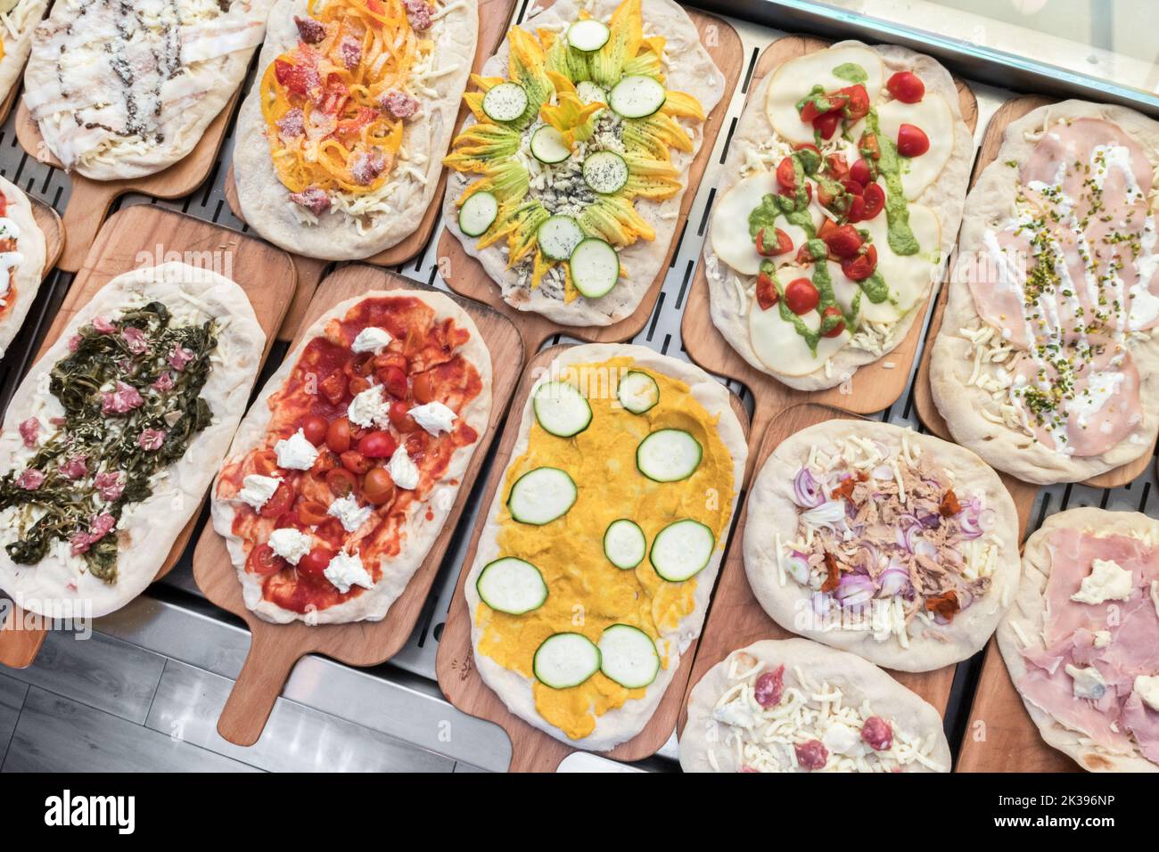 Variety of raw pizzas to bake. Restaurant. Pizzeria. Italian food Stock ...