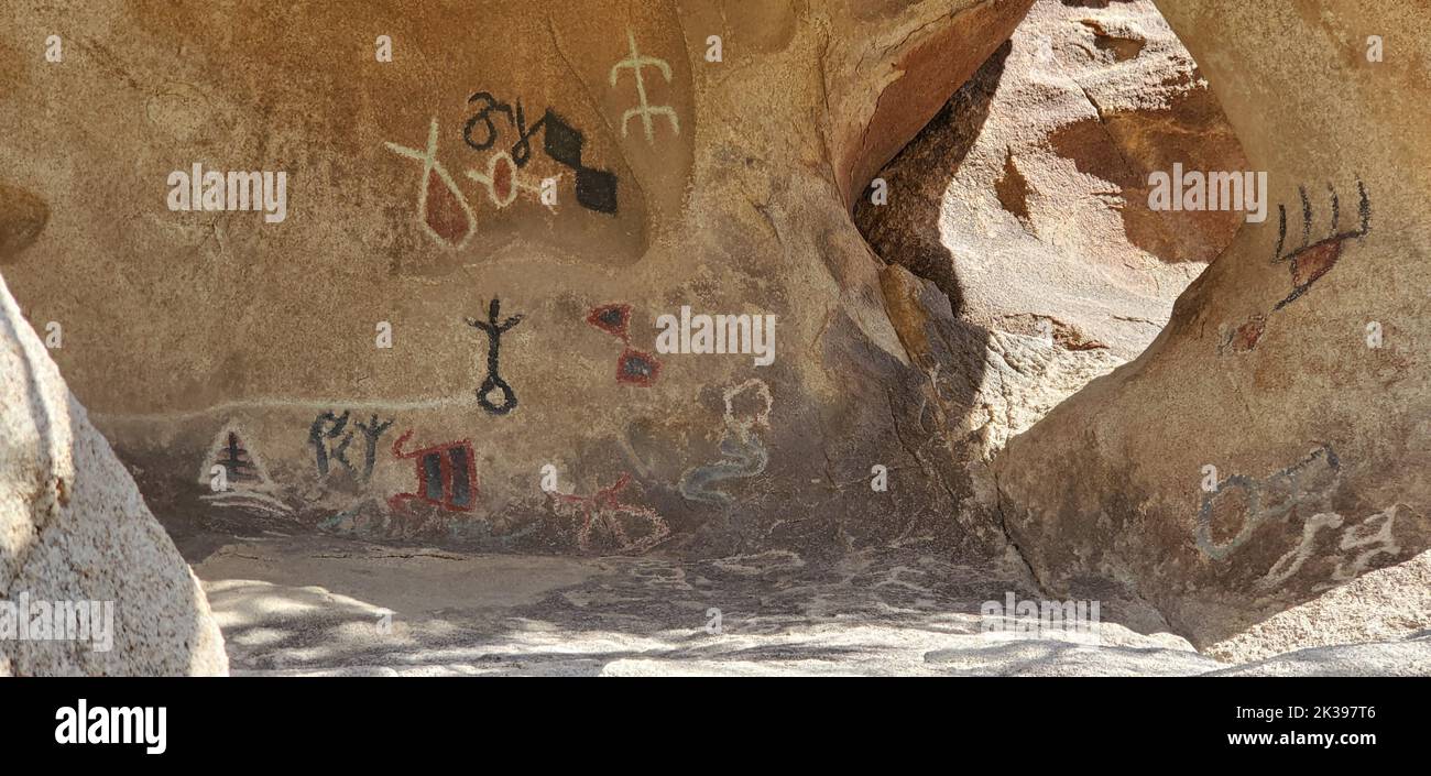 A natural stone wall with different signs and symbols at the Joshua ...