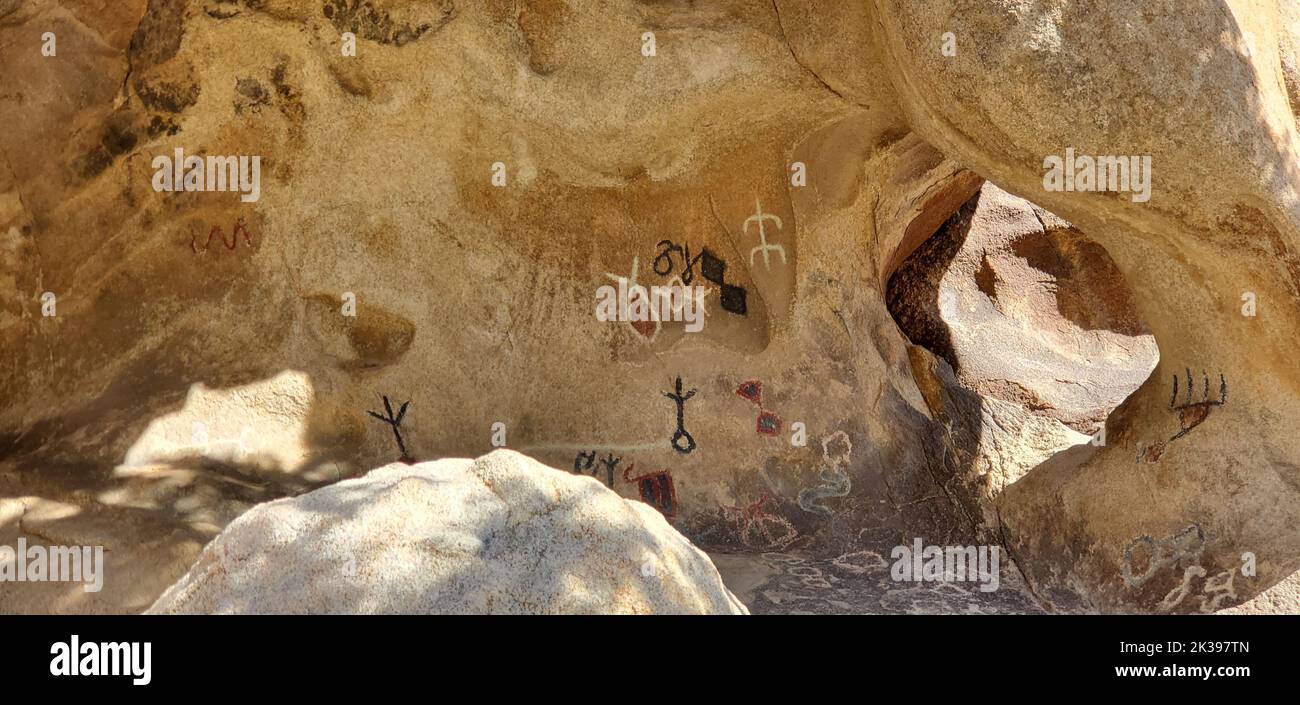 A natural stone wall with different signs and symbols at the Joshua ...