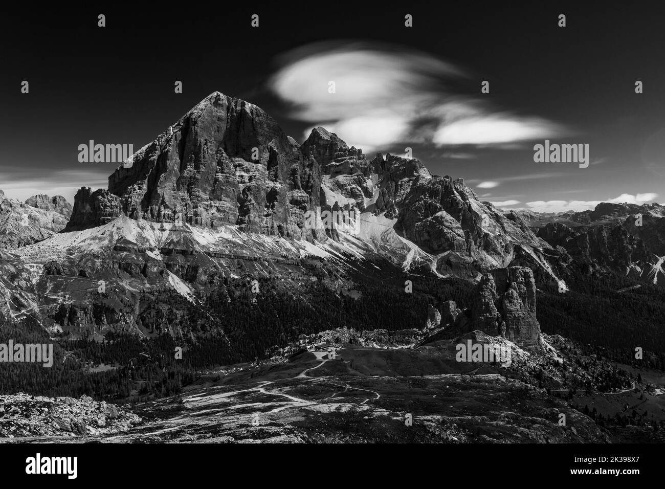A scenic grayscale of rocky Dolomitic Mountains in Italy with a ...