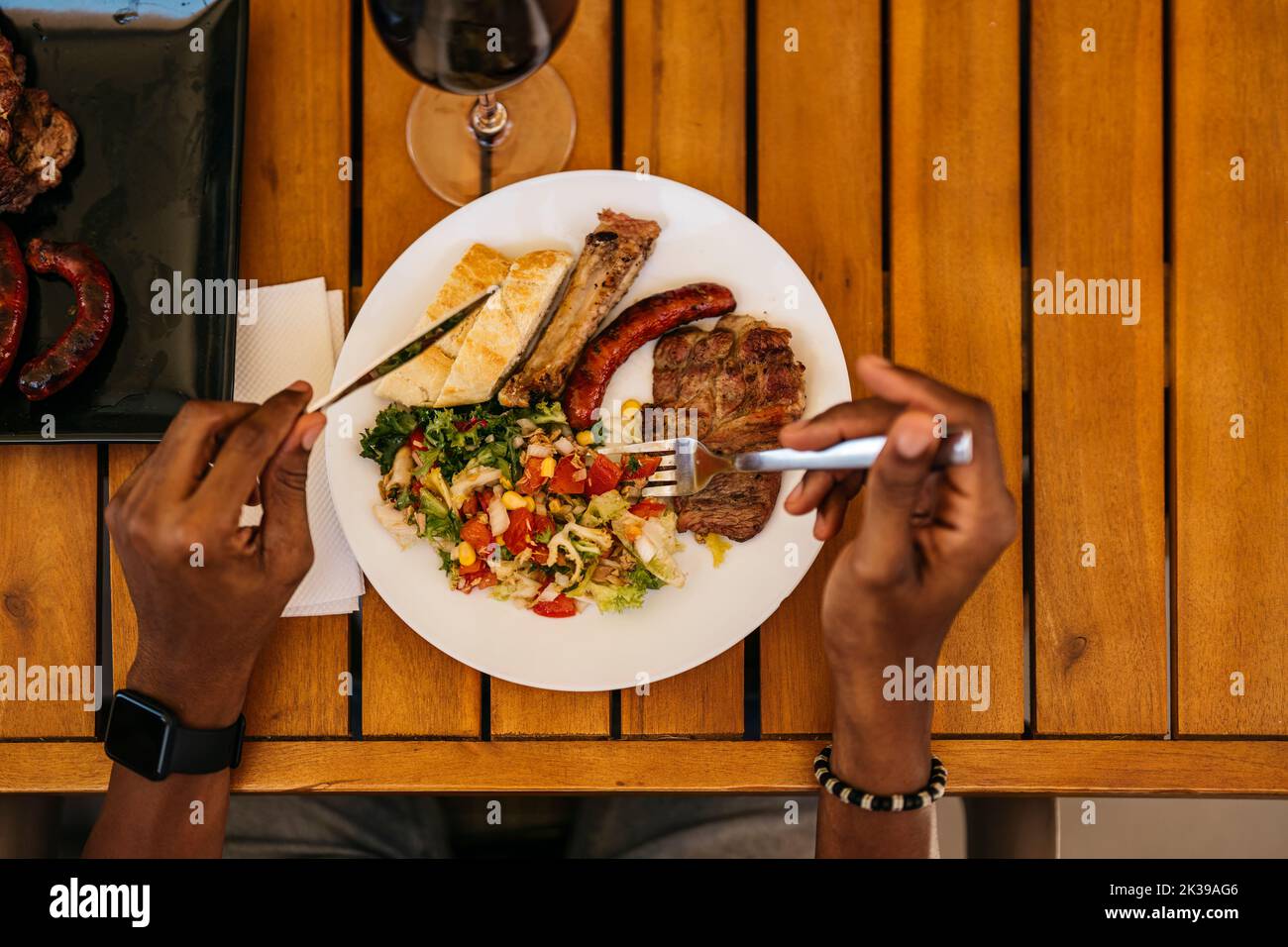 top view of a black man eating while seated at a table Stock Photo - Alamy