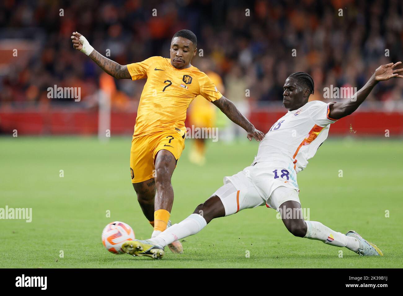 Netherlands' Steven Bergwijn and Belgium's Amadou Onana fight for the ball during a soccer game ...