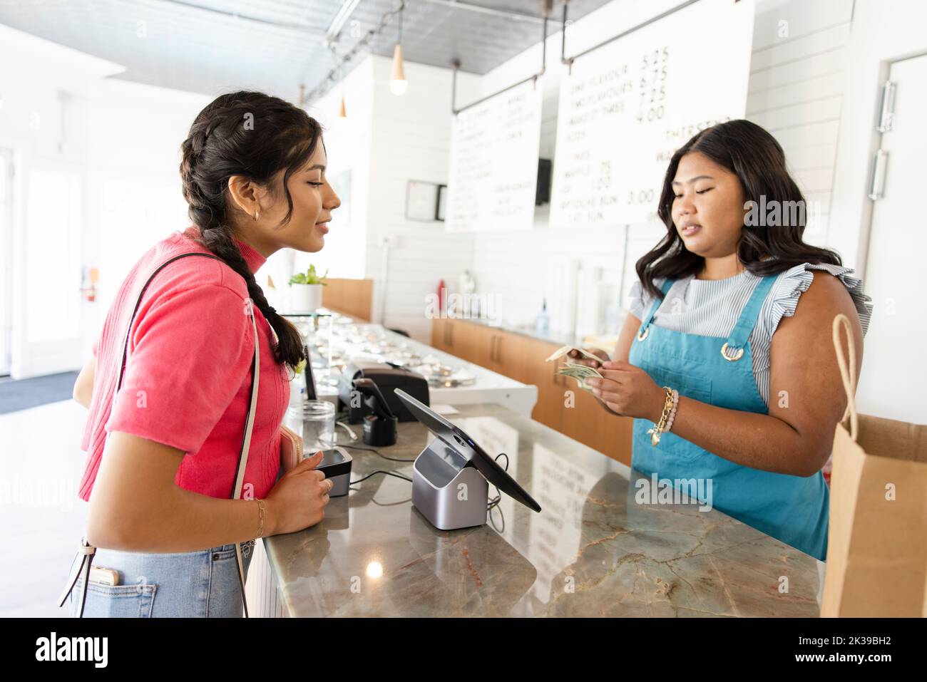 Female cash counter hi-res stock photography and images - Alamy