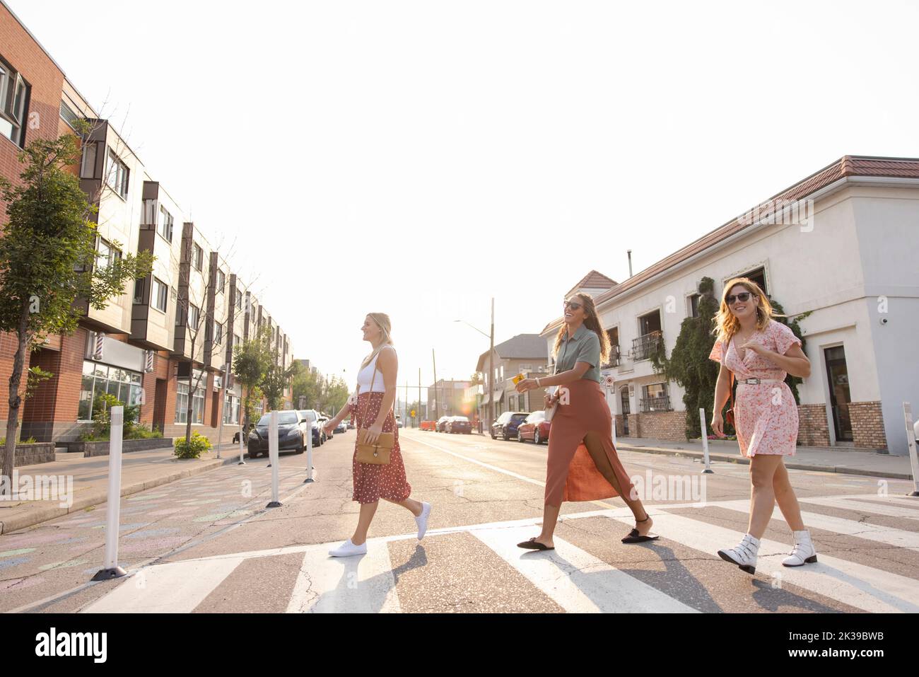 Woman walking across the road hi-res stock photography and images - Alamy