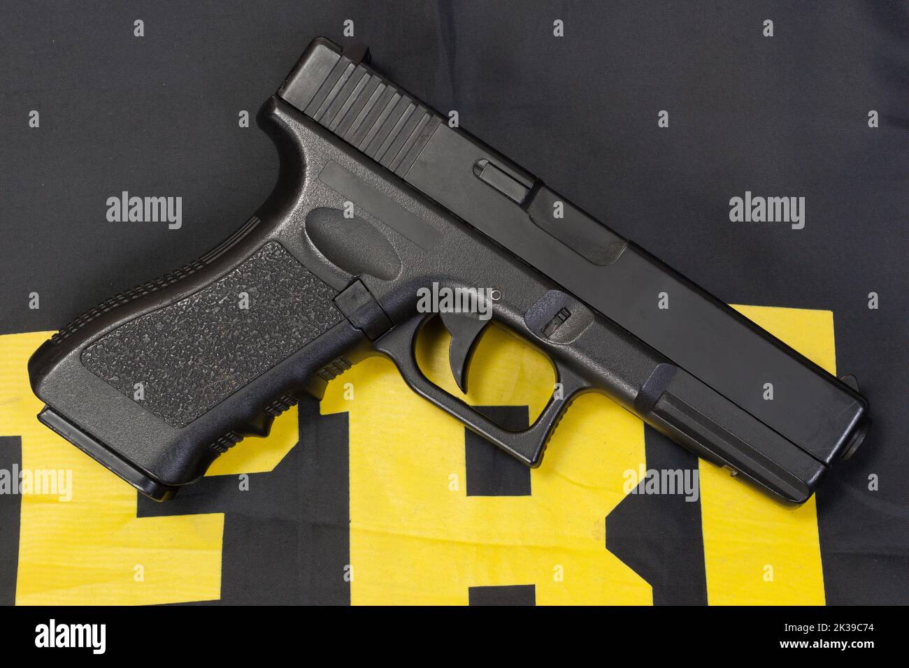 semi auto handgun on fbi raid jacket black uniform background Stock ...