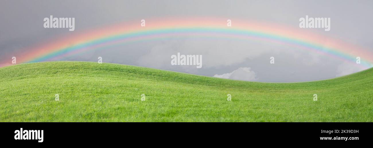 Grass Field with Rainbow in the Sky Stock Photo - Alamy