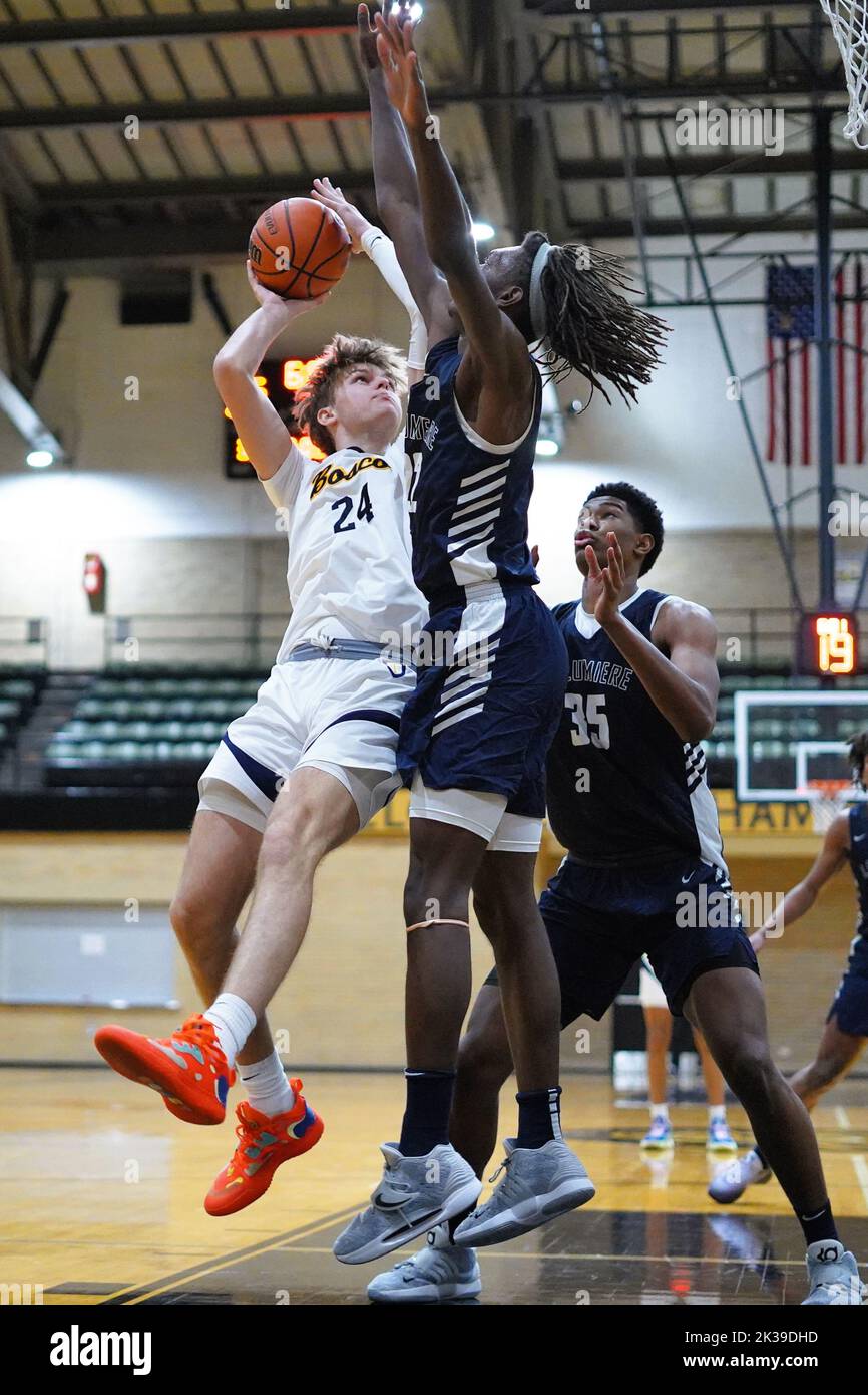 A vertical of athletic basketball players competing for the ball ...