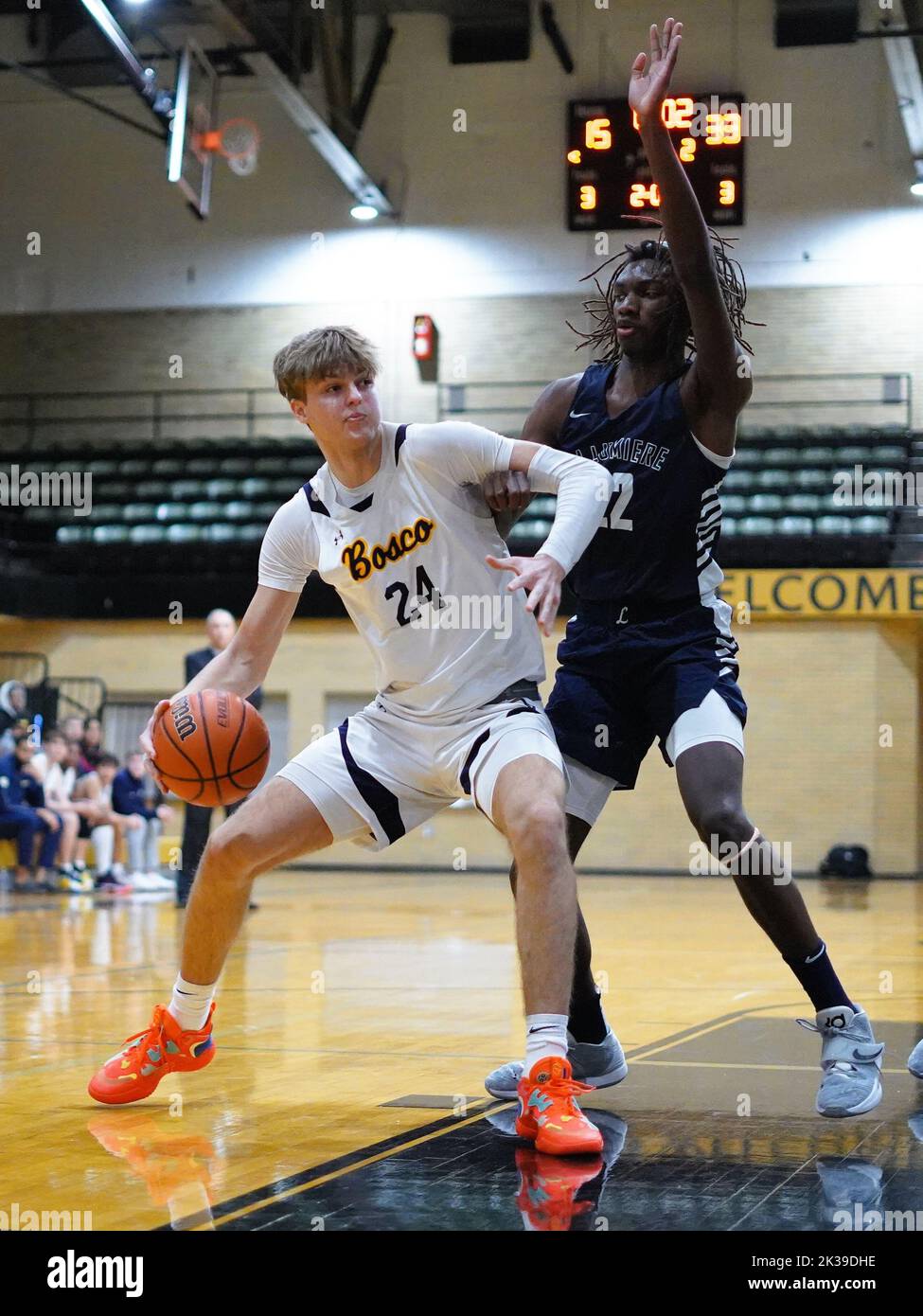 A vertical of athletic basketball players competing for the ball ...