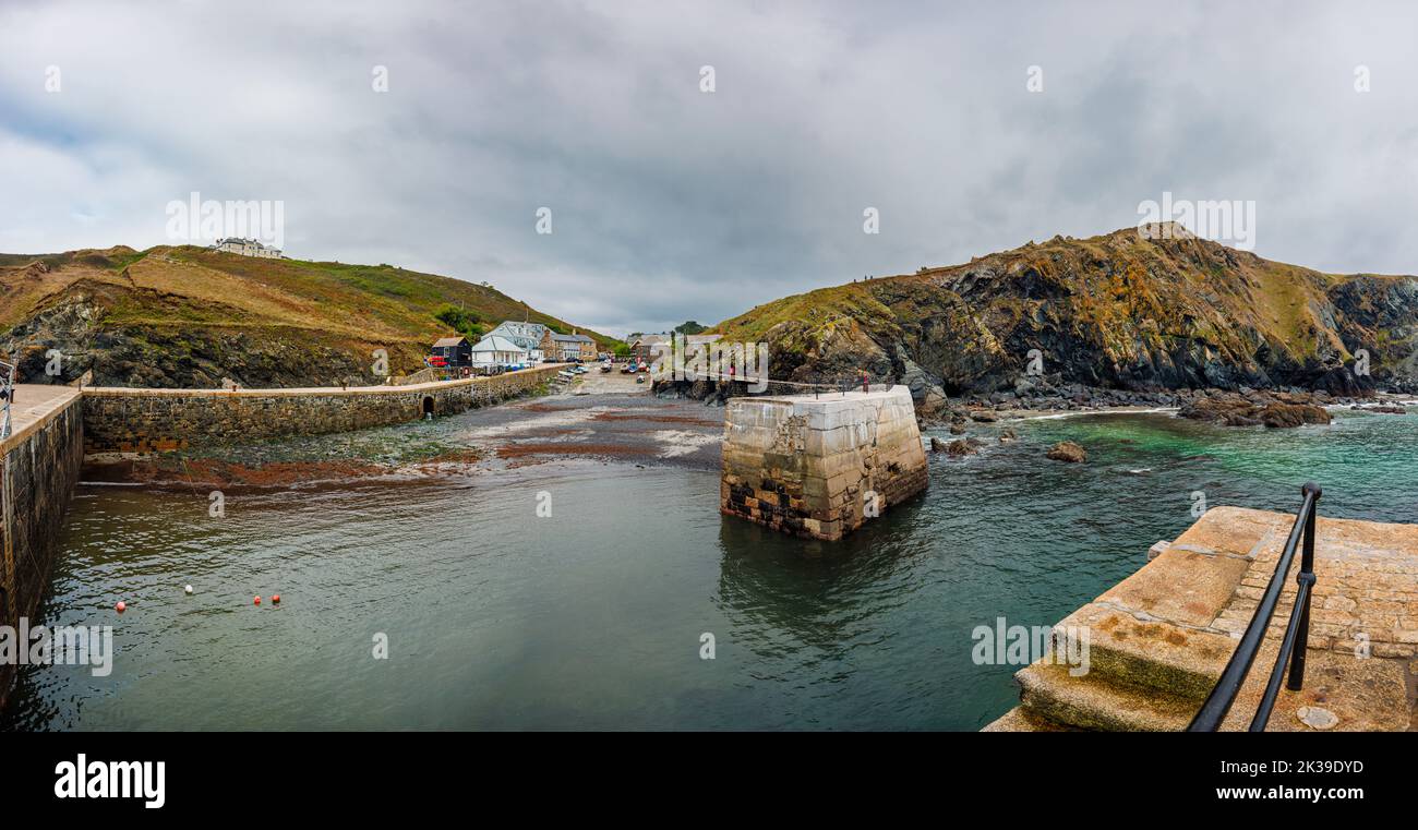 Mullion Cove harbour at low tide, cliffs and coastline on the west ...