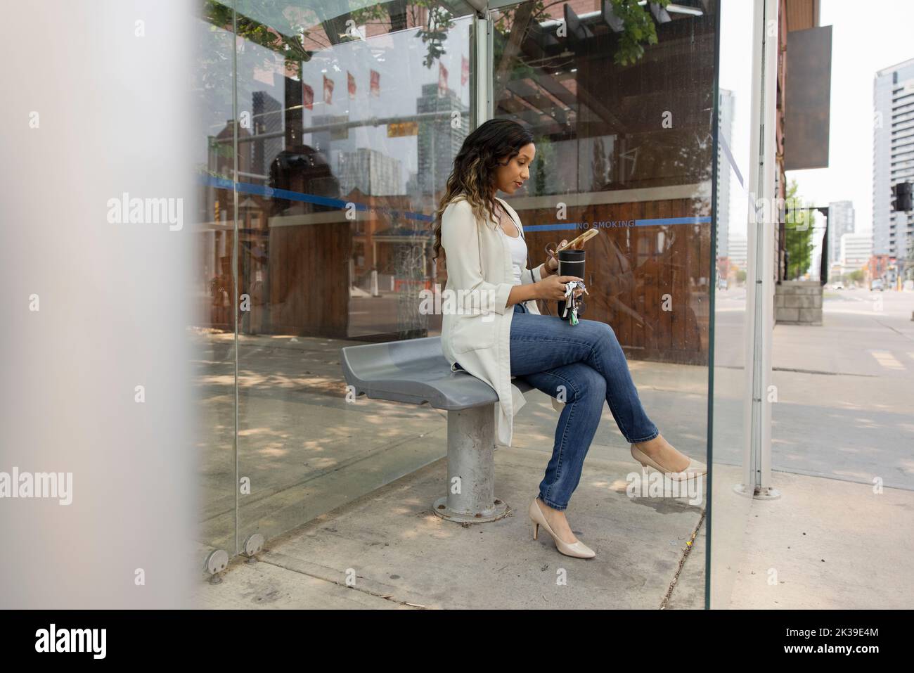 Mobile phone bus stop woman hi-res stock photography and images - Alamy