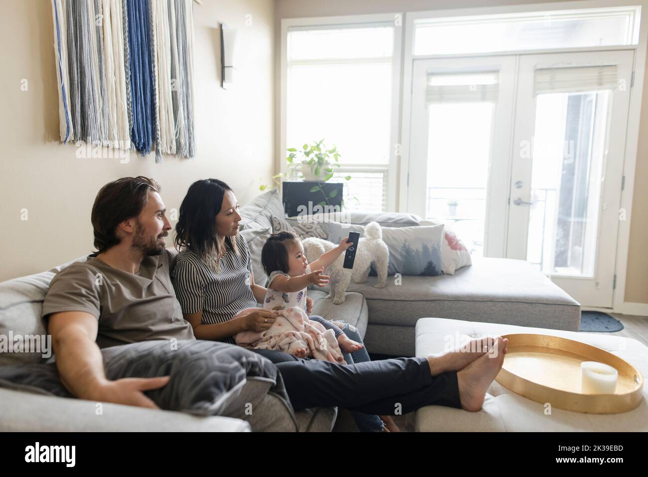 Couple with baby watching tv hi-res stock photography and images - Alamy