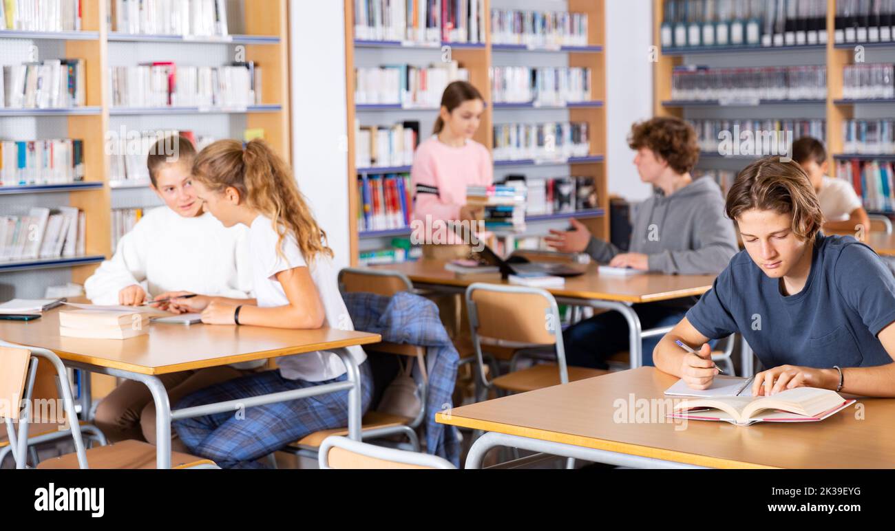 Group of girls and boys preparing for exams in library Stock Photo - Alamy