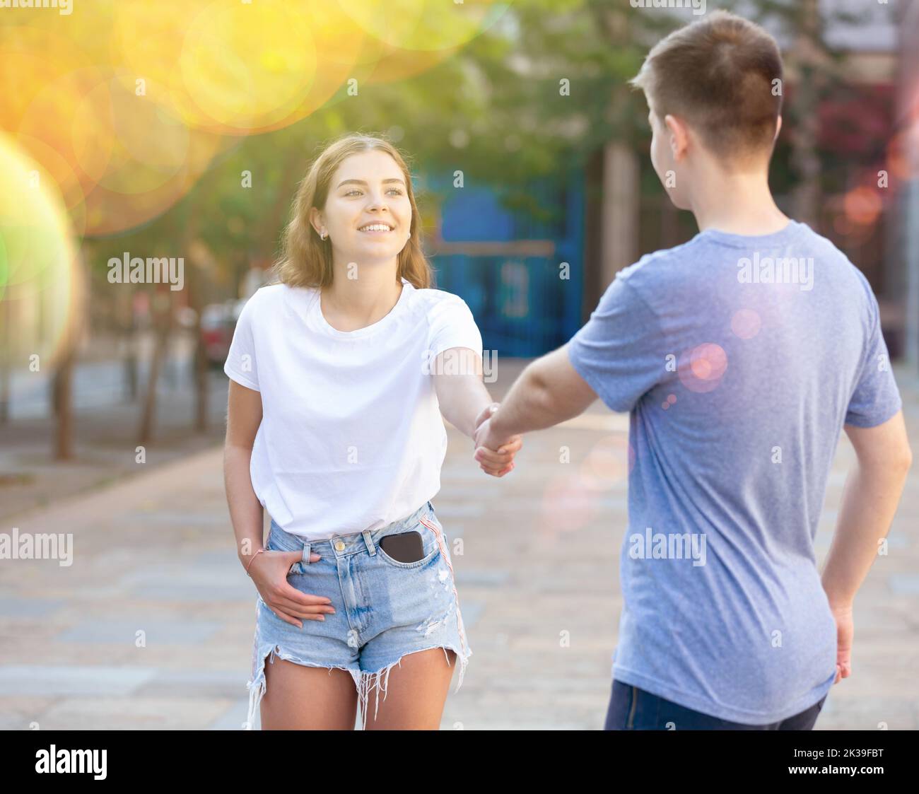 Two teenagers are walking hand in hand Stock Photo - Alamy