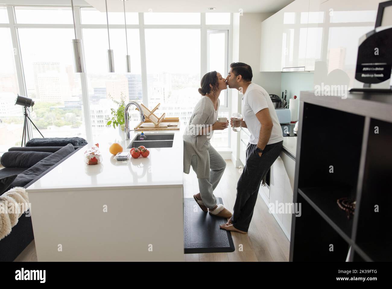 Man woman kissing kitchen hi-res stock photography and images - Alamy
