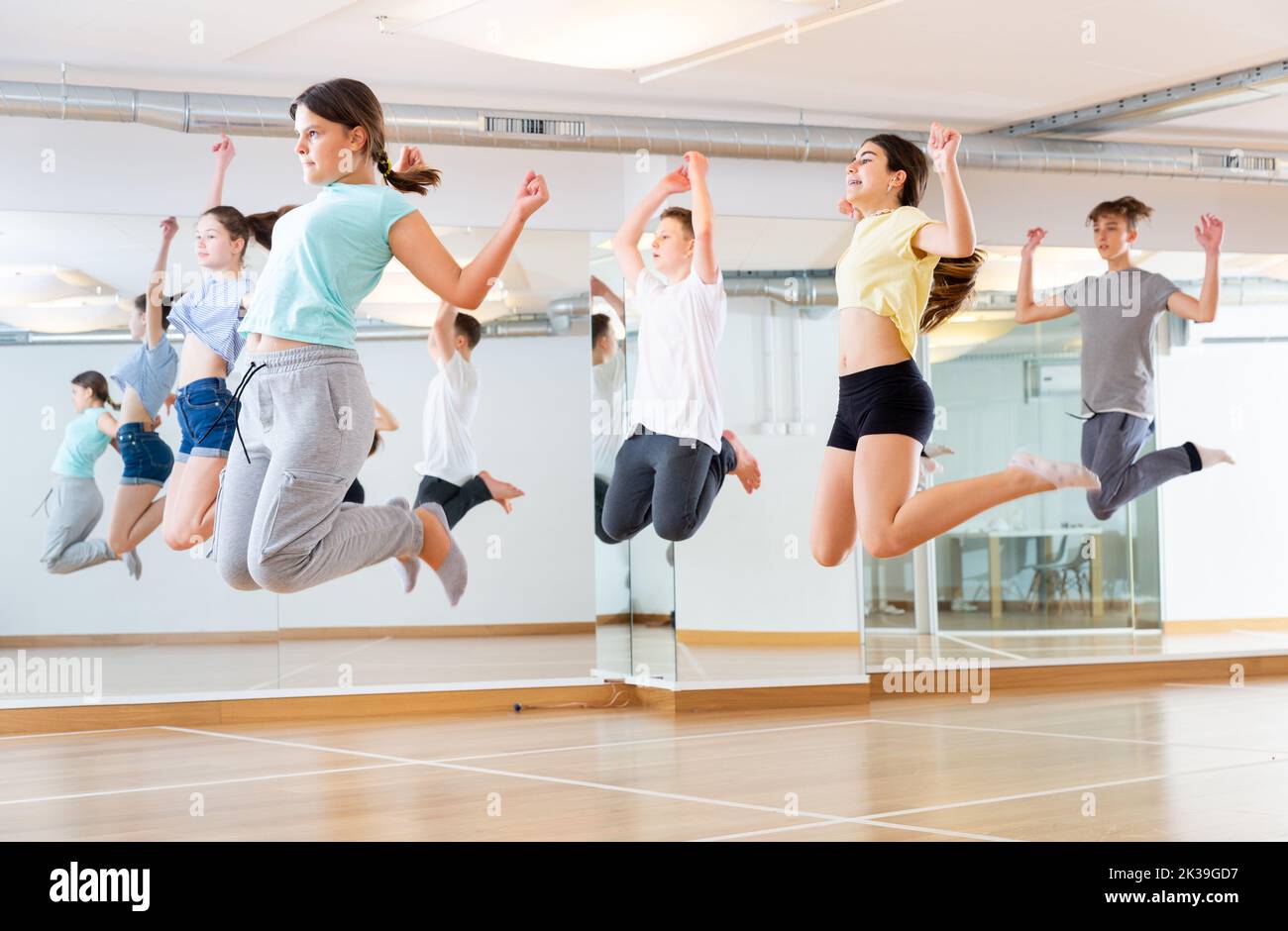 Group of cheerful tweens jumping during dances class Stock Photo - Alamy