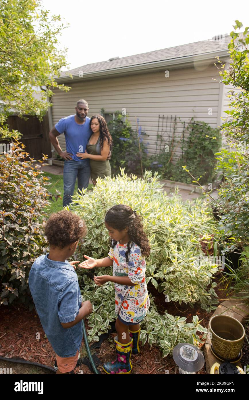 Parents watching children play garden hi-res stock photography and ...