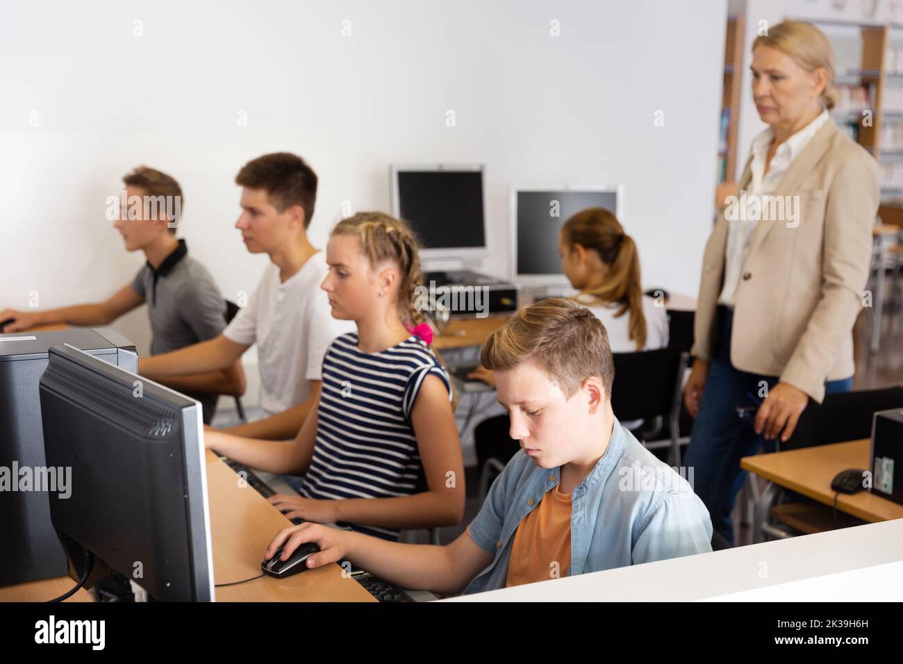 Students working with computers in classroom Stock Photo - Alamy
