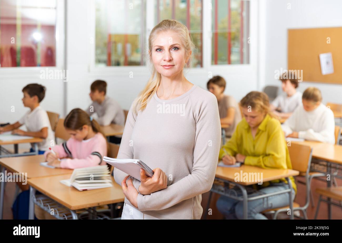Portrait of positive female school teacher Stock Photo - Alamy