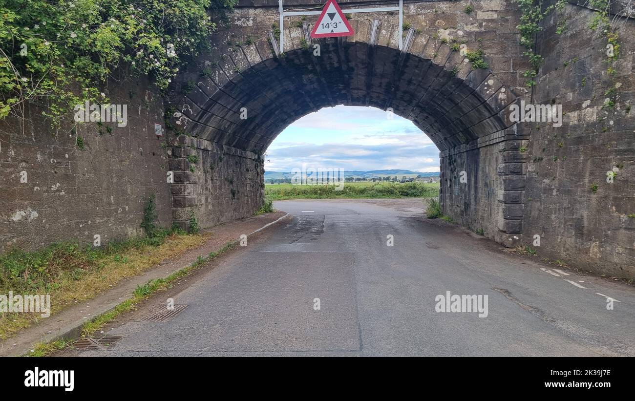 A beautiful view of a stone bridge over an empty road Stock Photo - Alamy