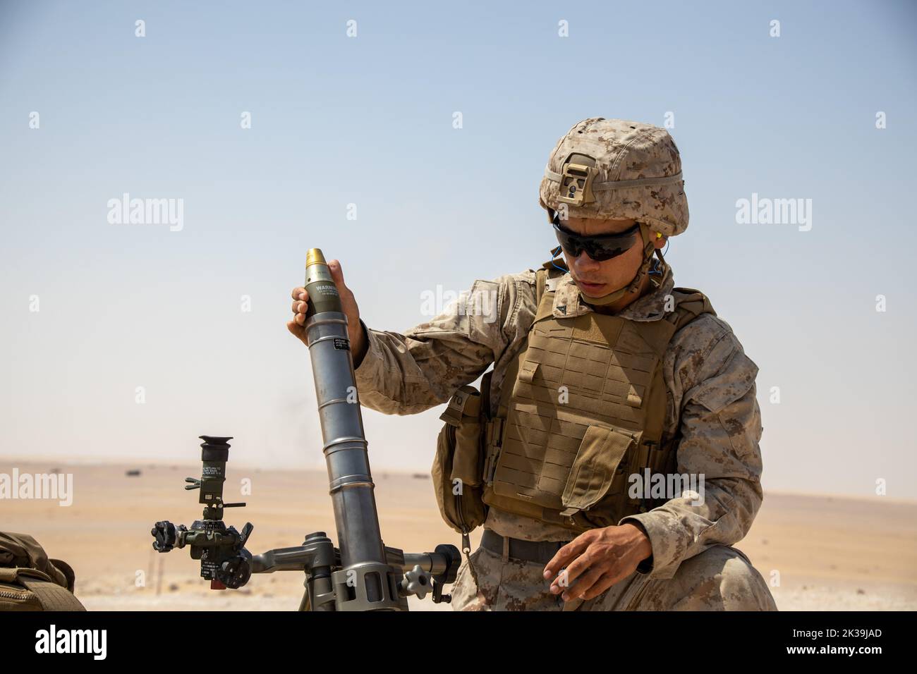 A U.S. Marine with 3rd Battalion, 5th Marine Regiment, 1st Marine Division, fires an M224 60mm ...