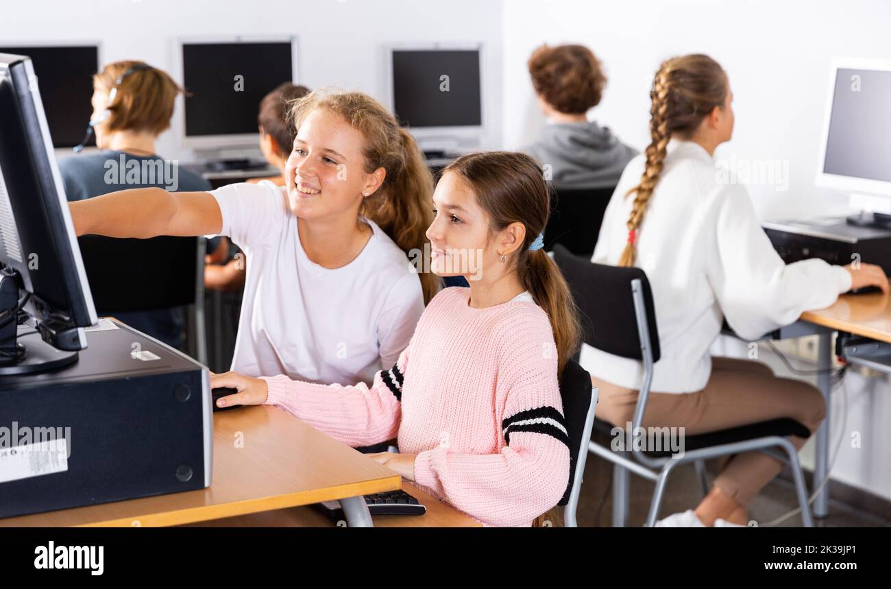 Teenage boys and girls using computers in IT class room Stock Photo - Alamy