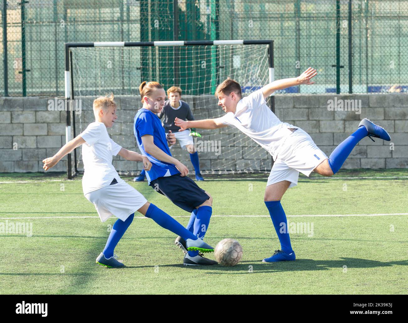 Young football players fighting for ball Stock Photo - Alamy