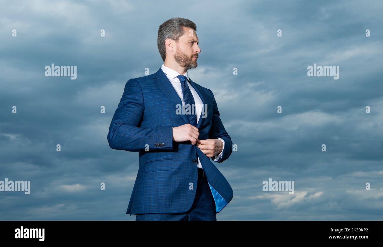 Professional man sky background. Grizzled man buttoning suit. Serious ...