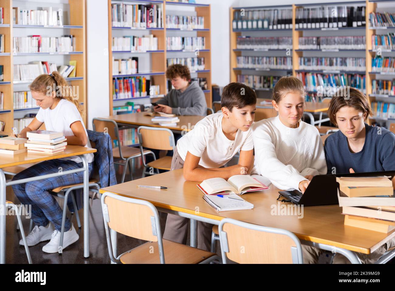 Teenage boys and girls in library Stock Photo - Alamy