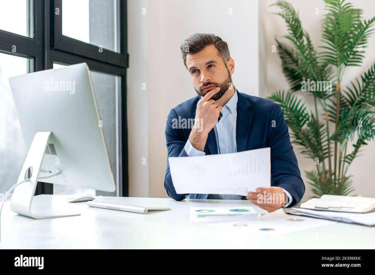 Pensive thoughtful caucasian businessman, corporate director, sits in ...