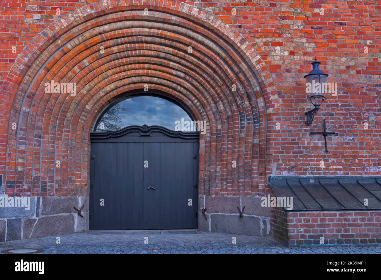 Beautiful medieval building with arches and walls decorated with brown ...