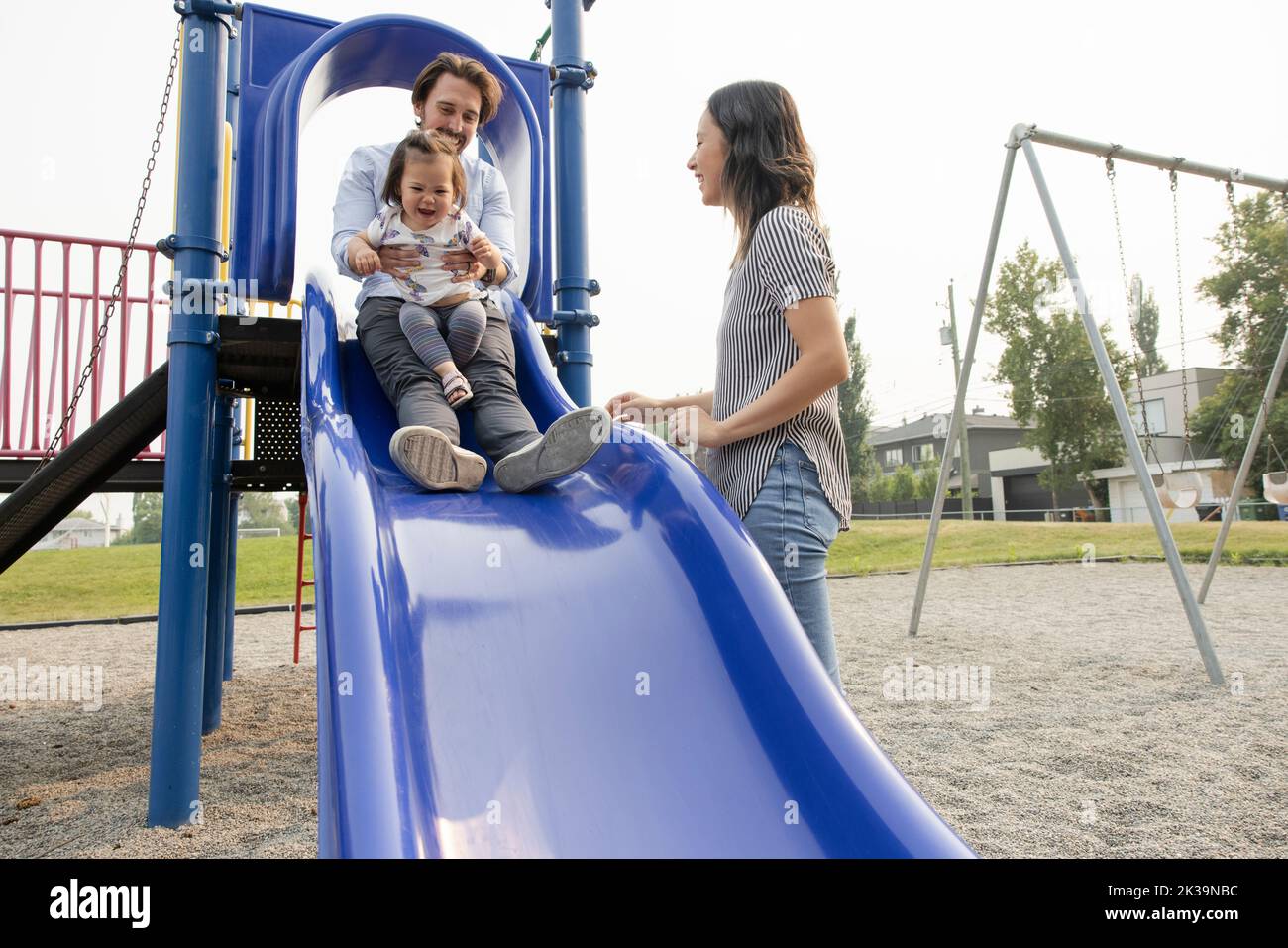 Playground slide man standing hi-res stock photography and images - Alamy