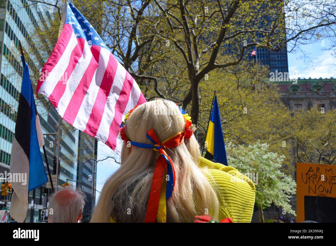The back of a girl in a colorful head ribbon symbolizing Ukrainian flag ...