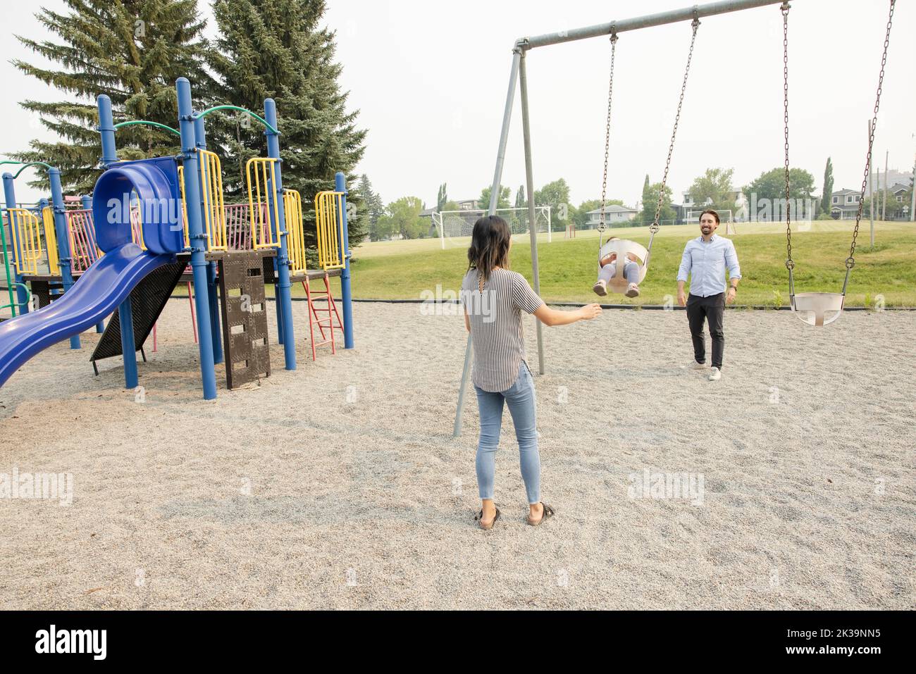 Pushing baby on swing hi-res stock photography and images - Alamy