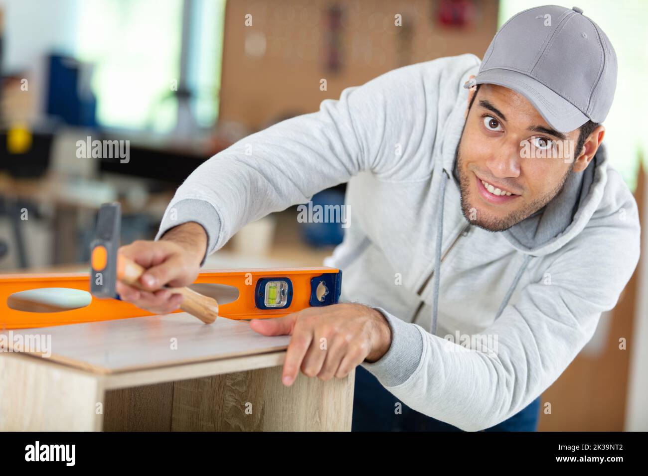 engineer or carpenter man measuring wood with building level Stock ...