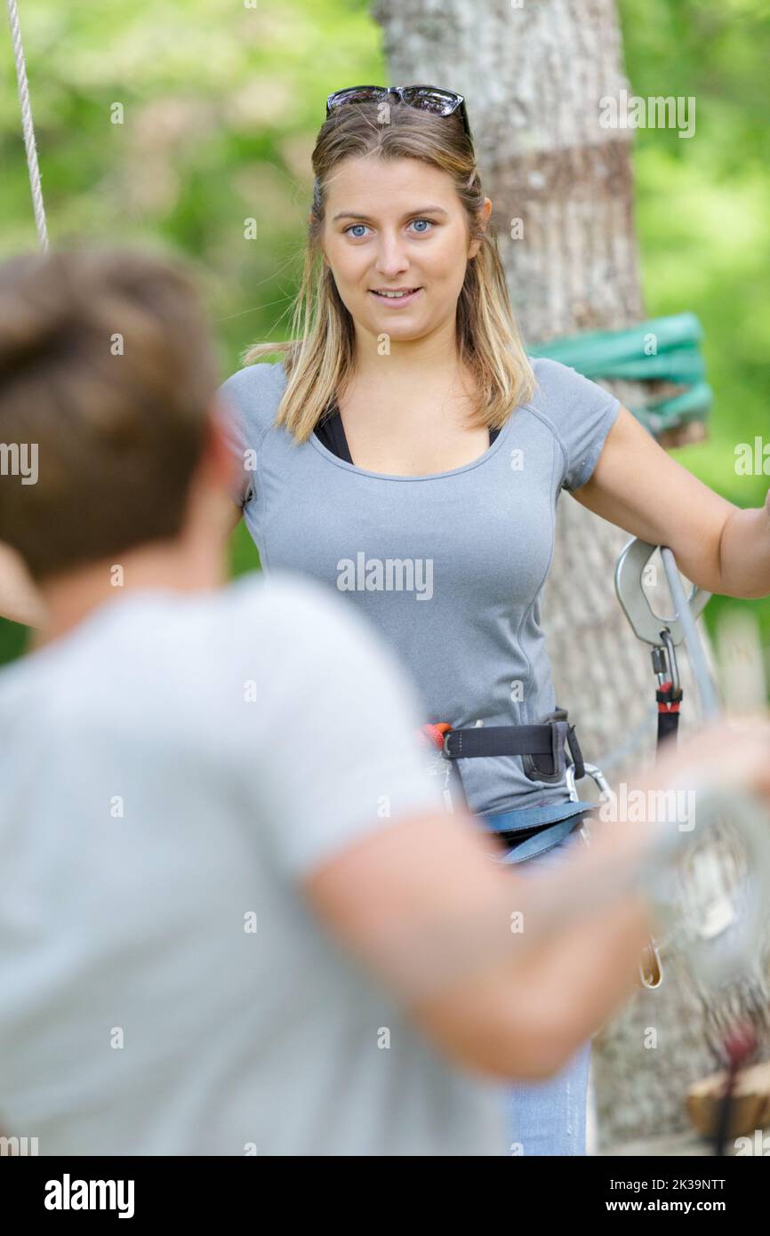 couple climbing in rope park Stock Photo - Alamy