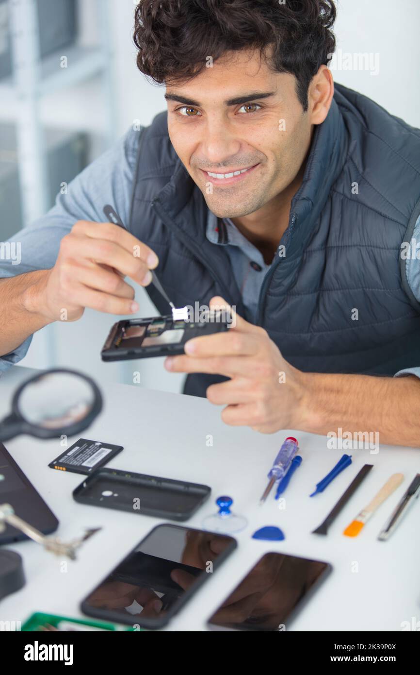 Electronics repair disassembled cell phone hi-res stock photography and ...