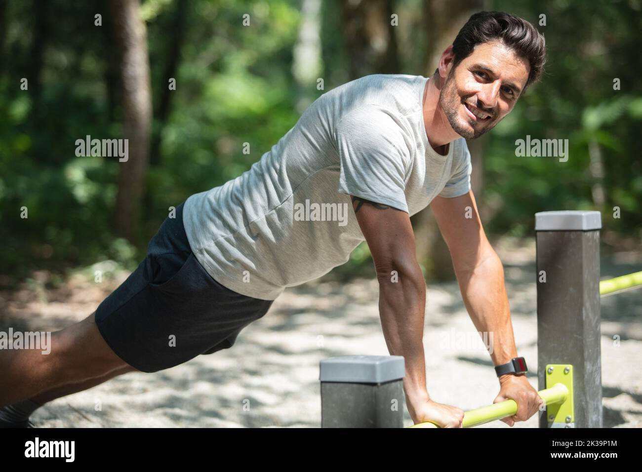 male athlete on parallel bars outdoors Stock Photo - Alamy
