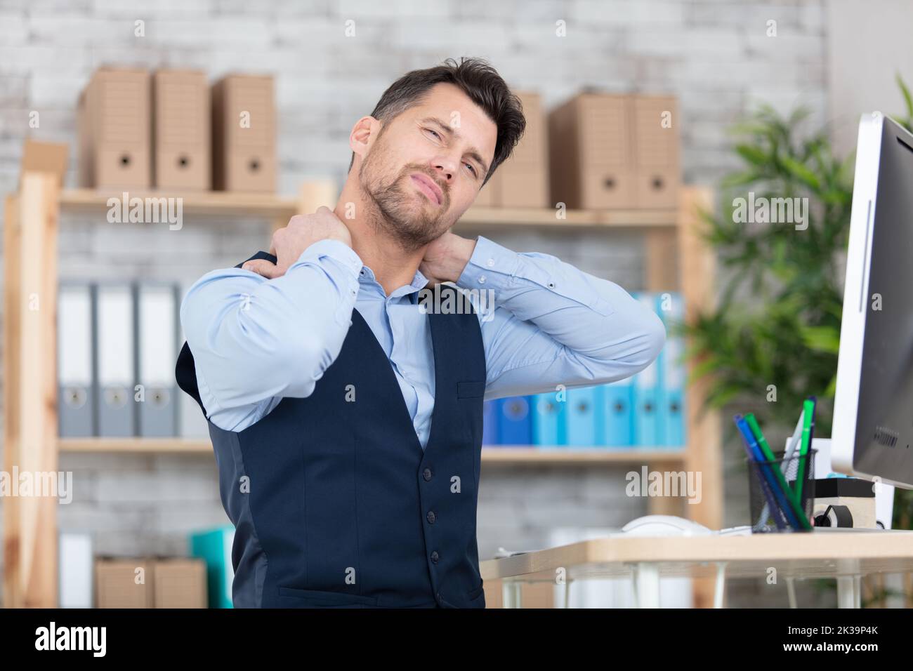 young frustrated freelancer is having a strong pain in neck Stock Photo ...