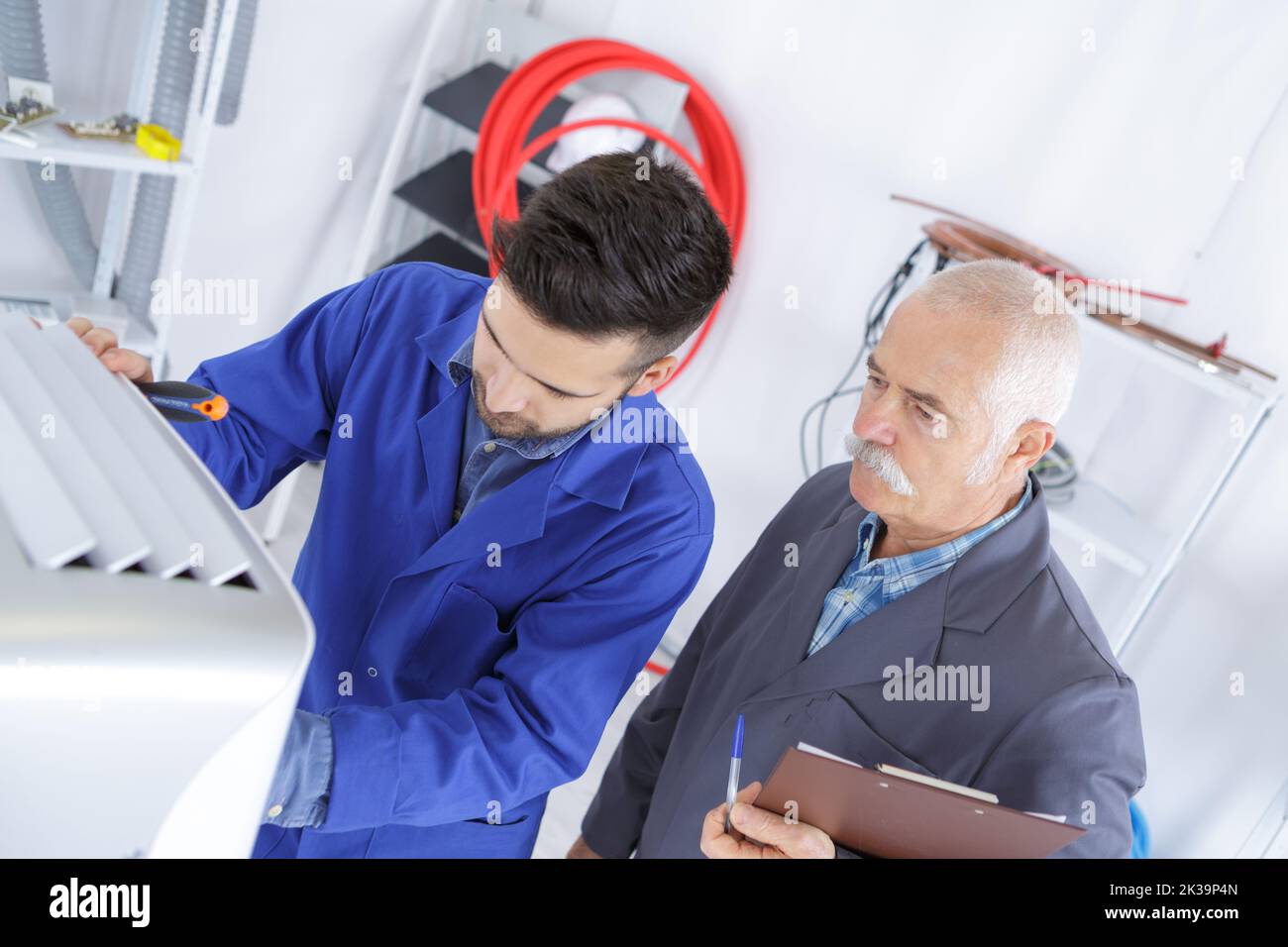 aircon maintenance man and teacher Stock Photo - Alamy
