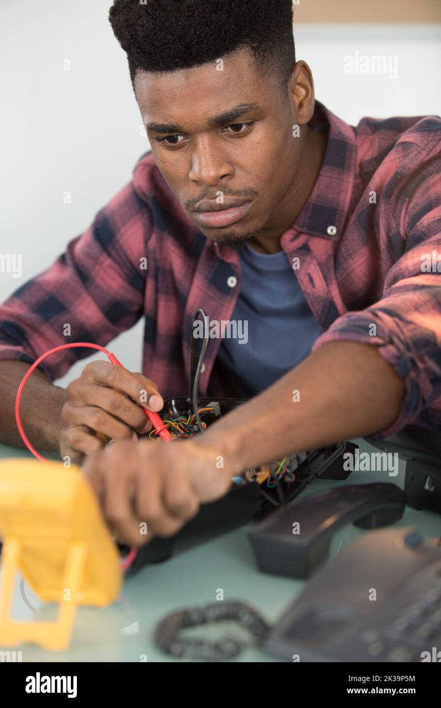 a computer repairman using multimeter Stock Photo - Alamy